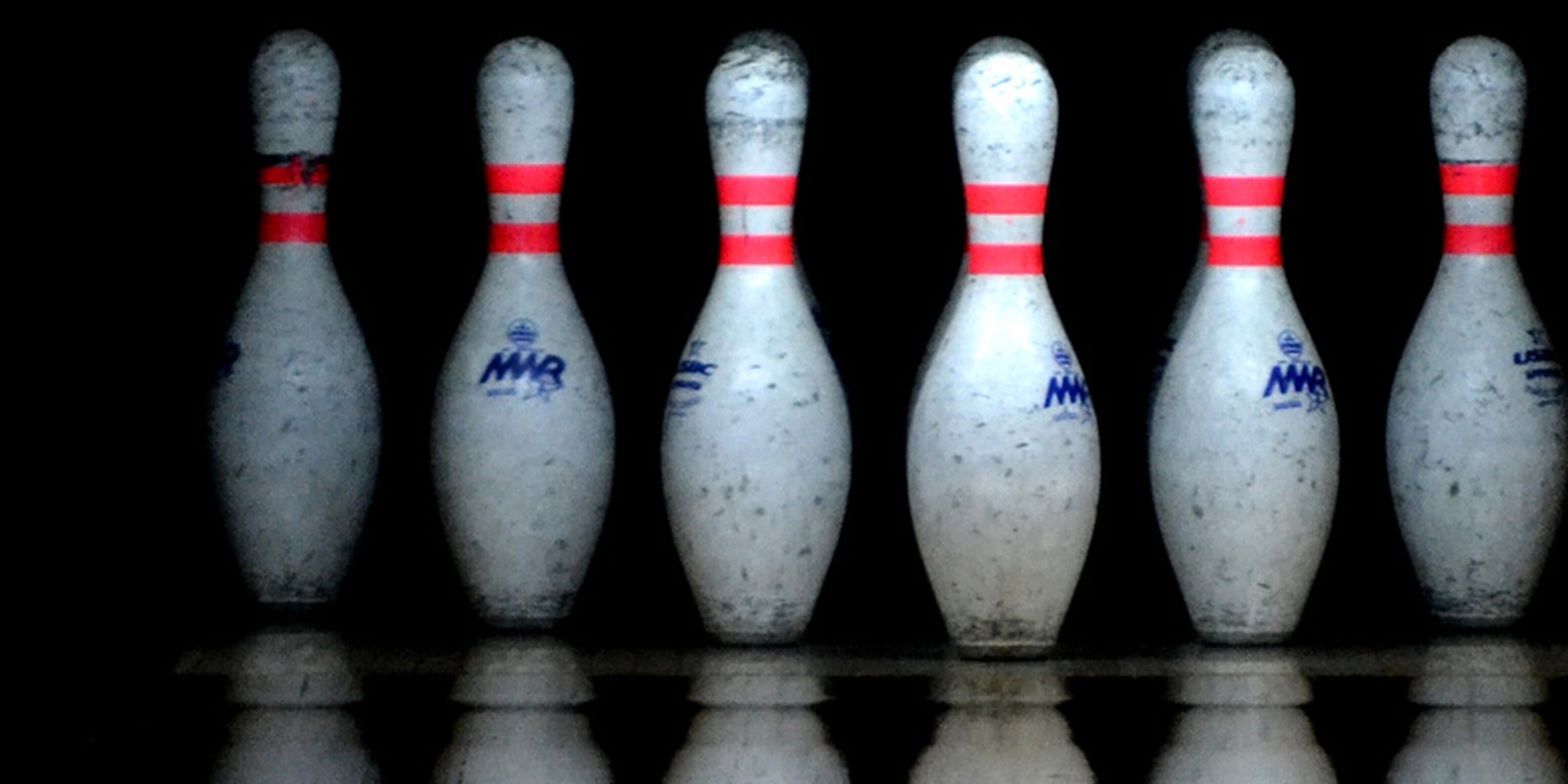 Curious dog is determined to figure out bowling alley sensor