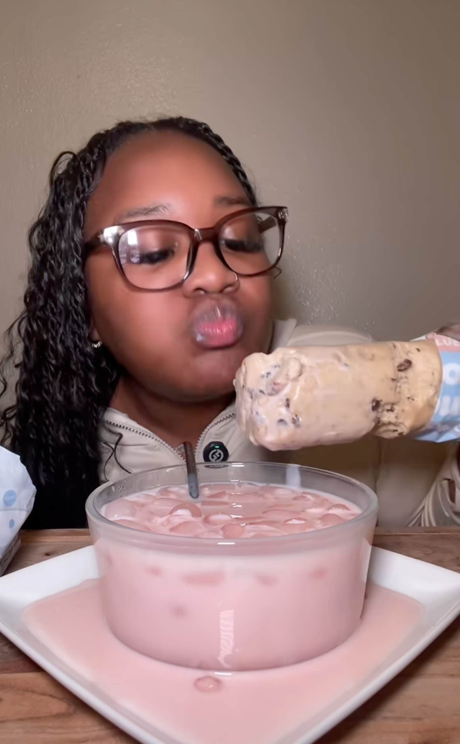 Woman dips raw cookie dough in strawberry milk in viral mukbang—critics ...
