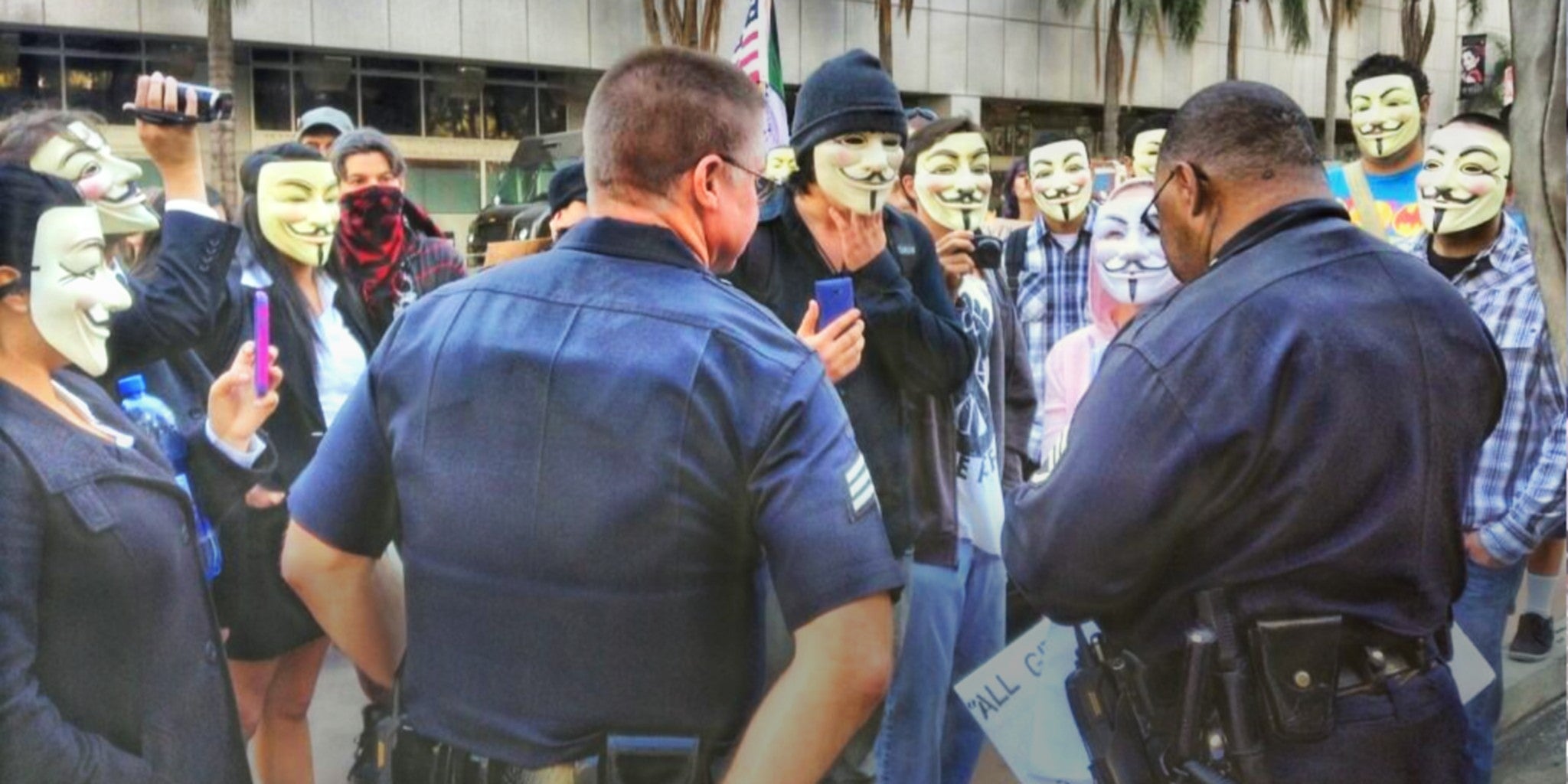 In trademark masks, Anonymous makes its presence felt worldwide